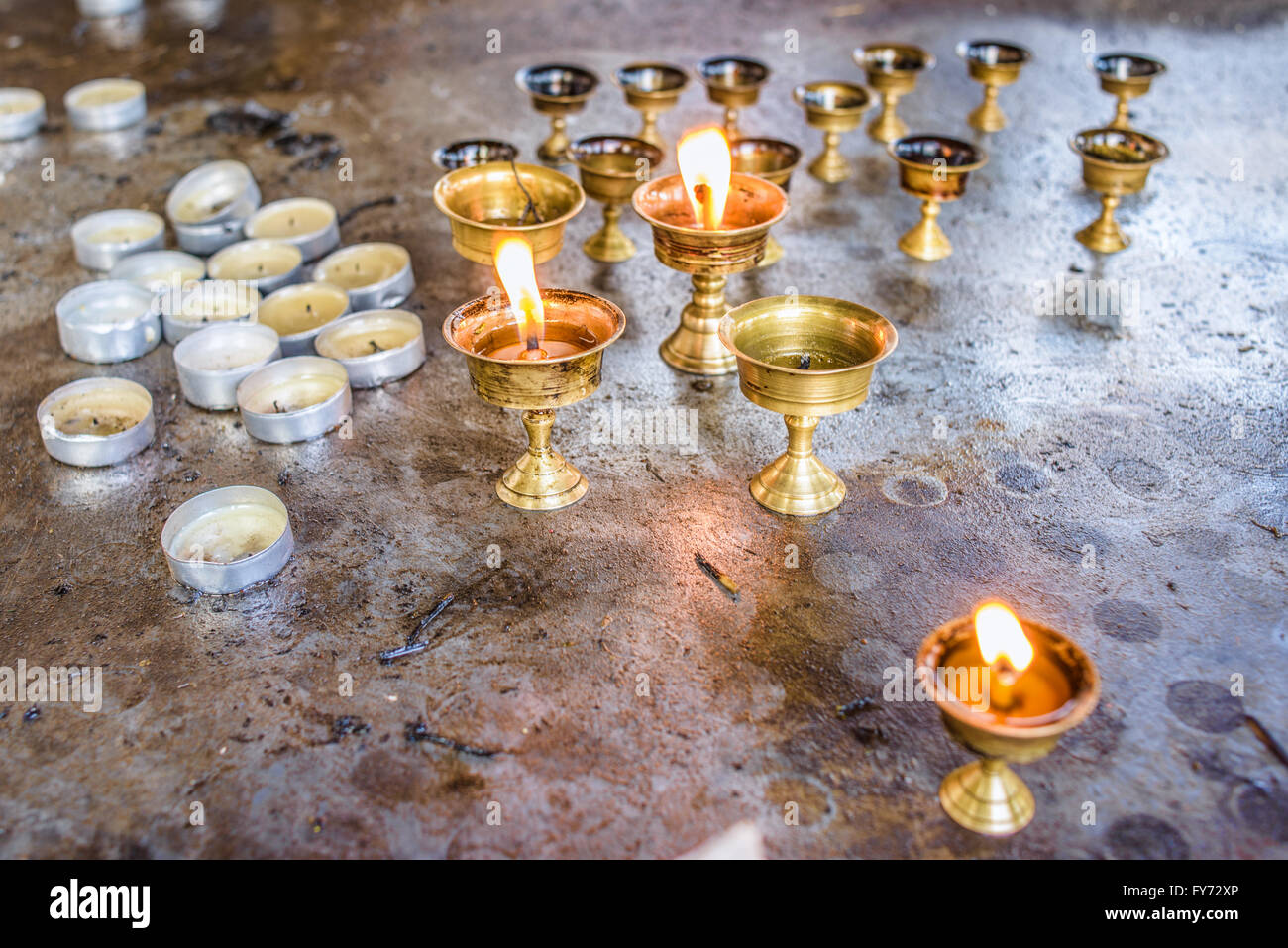 Burning candles in temple Stock Photo - Alamy