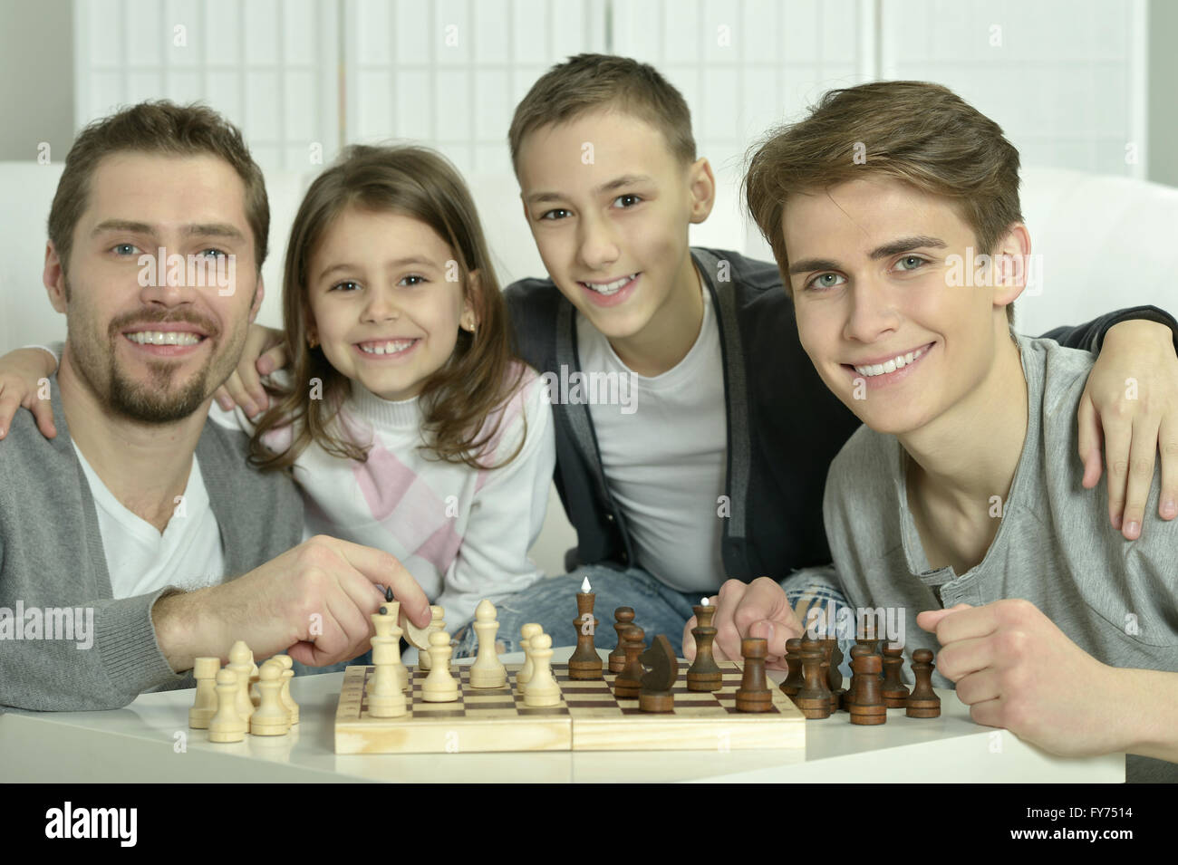 Family playing chess at home Stock Photo - Alamy
