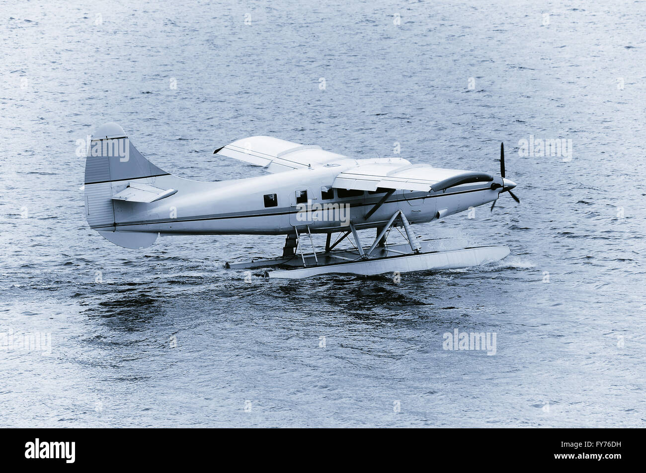 Taking off the small passenger plane from the water surface Stock Photo ...