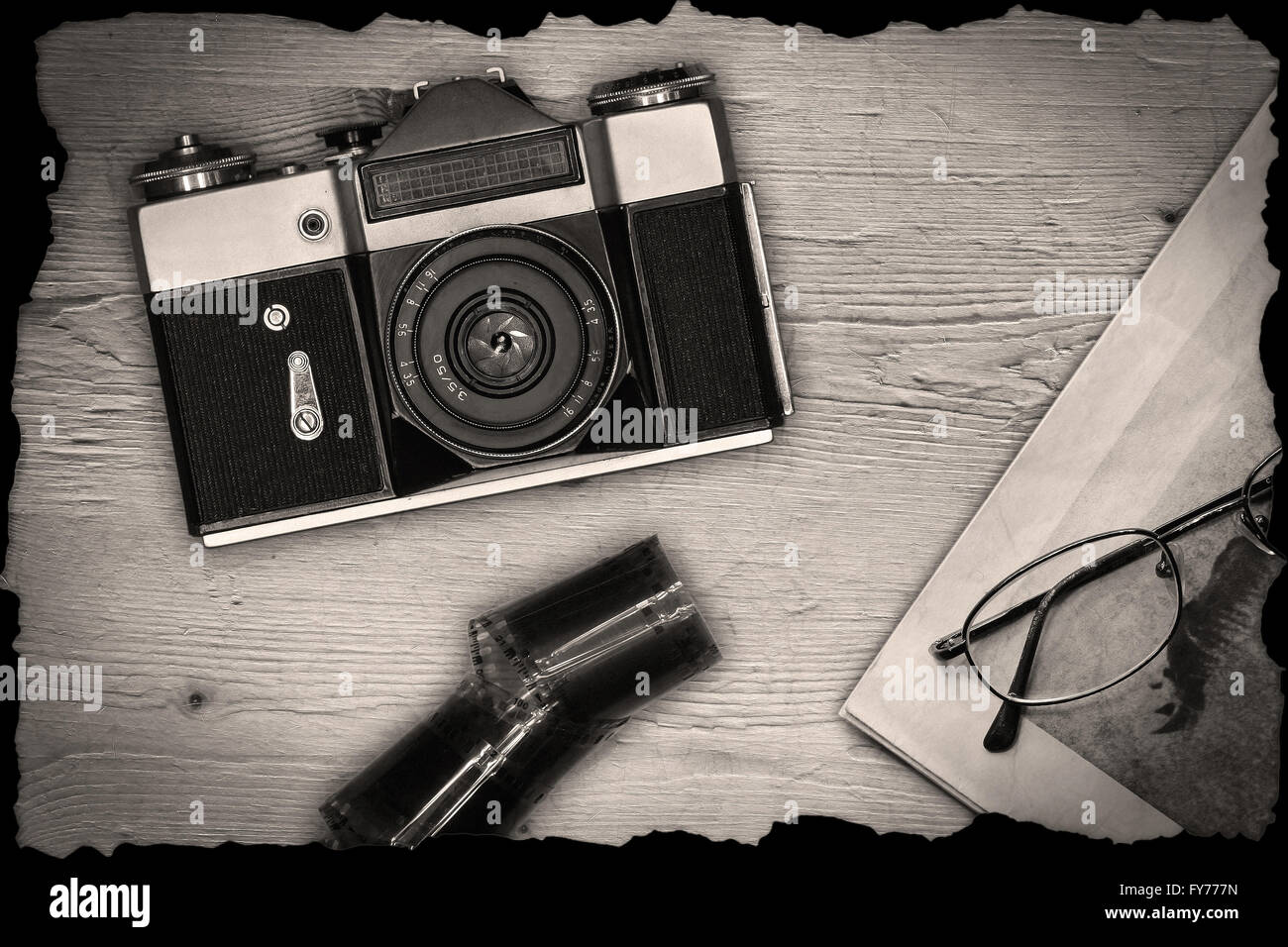 Old manual camera with newspaper, glasses and film on wooden desk Stock ...