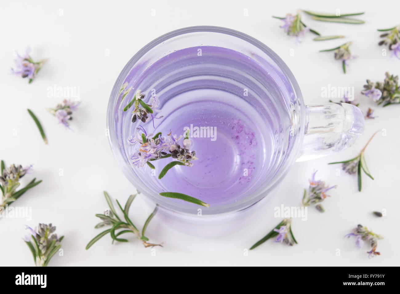 Colored rosemary tea with fresh rosemary flowers scattered Stock Photo ...