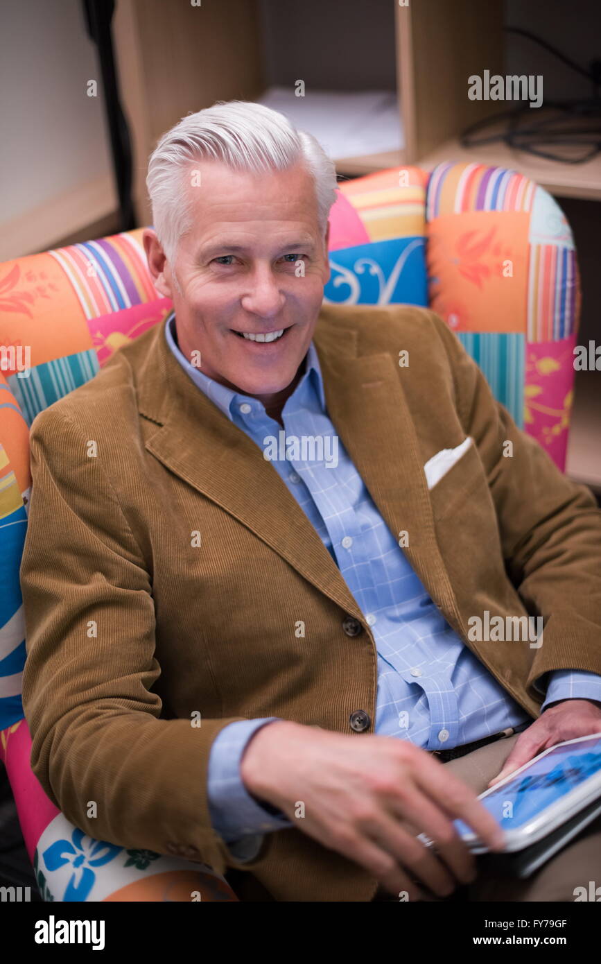 portrait of confident teacher sitting in colorful chair Stock Photo - Alamy