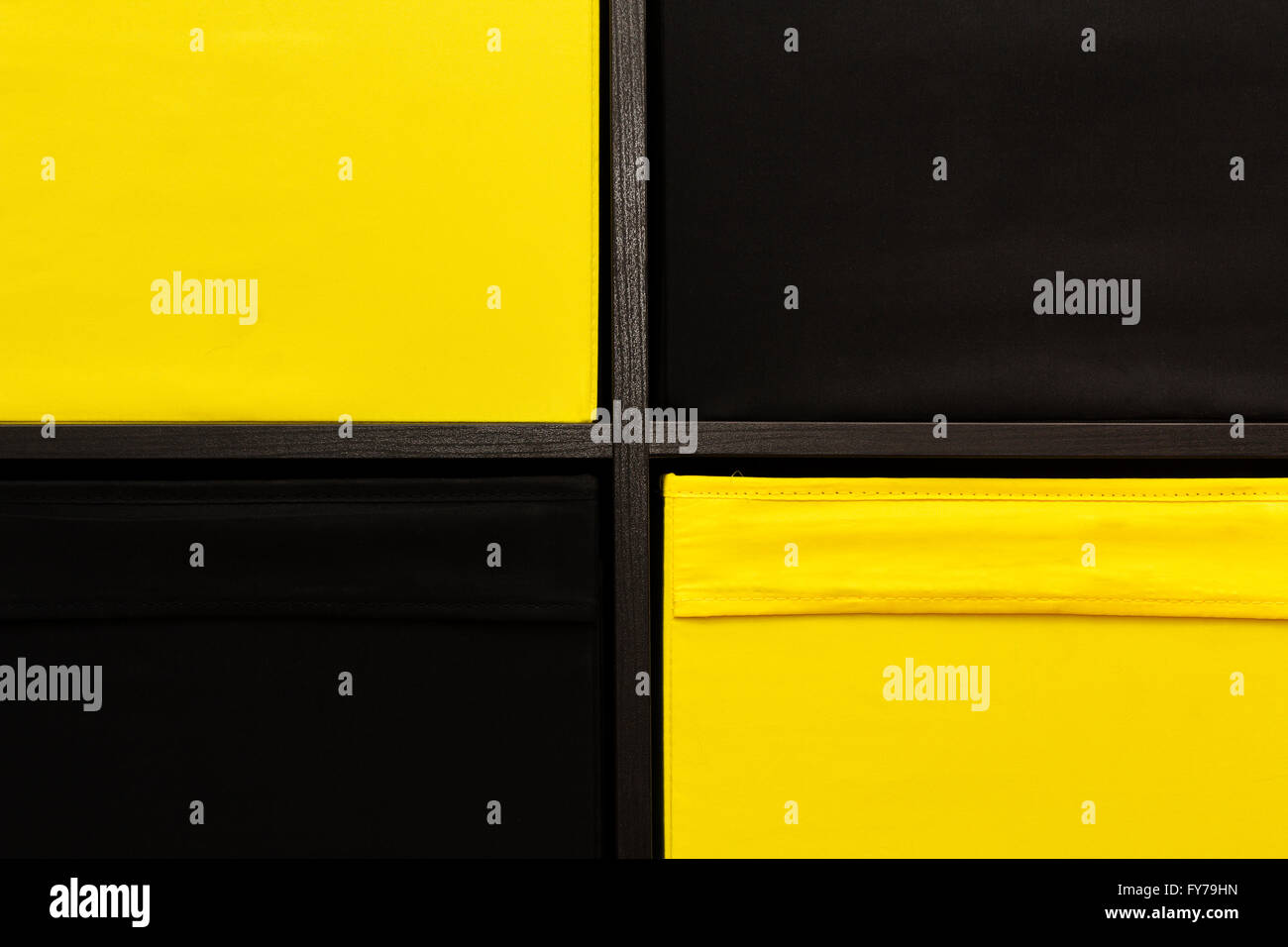 Abstract black and yellow drawers with wooden frame shown from the ...