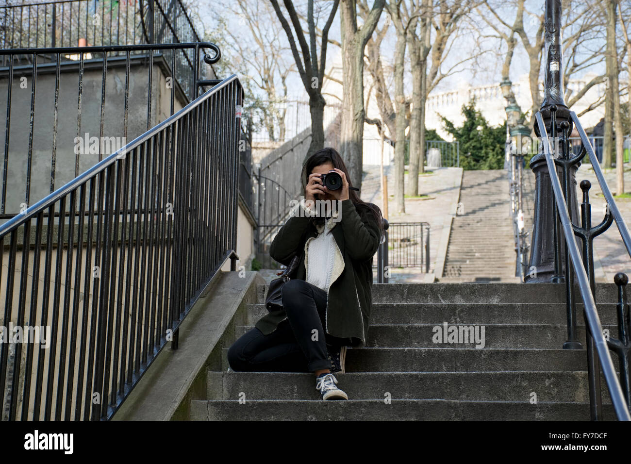 A woman snapping a picture with a DSLR camera Stock Photo - Alamy