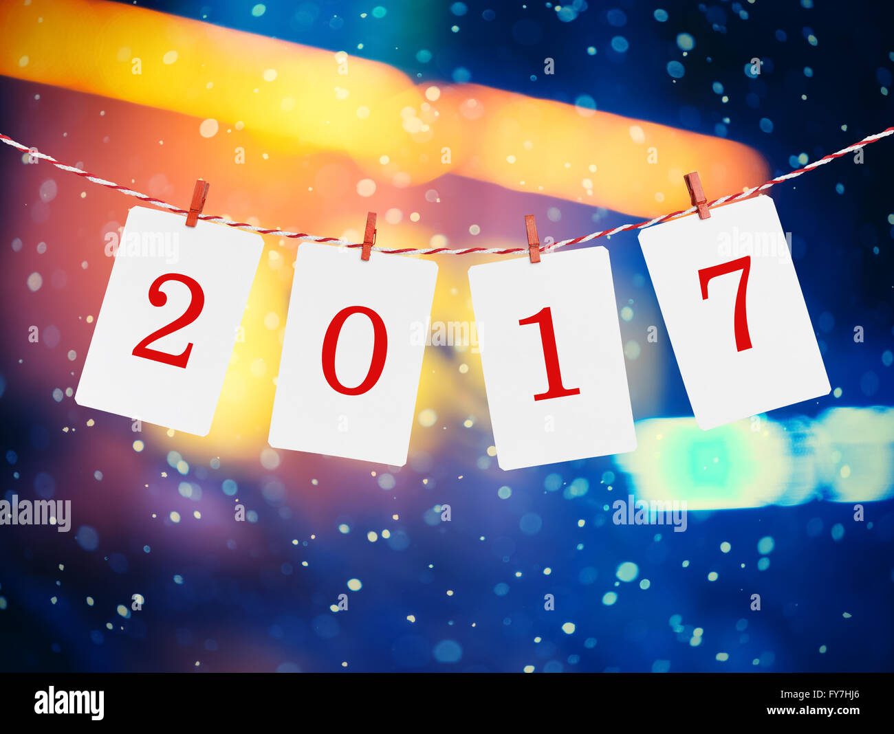 Paper or photo frames with 2017 figures hanging on the red striped rope ...