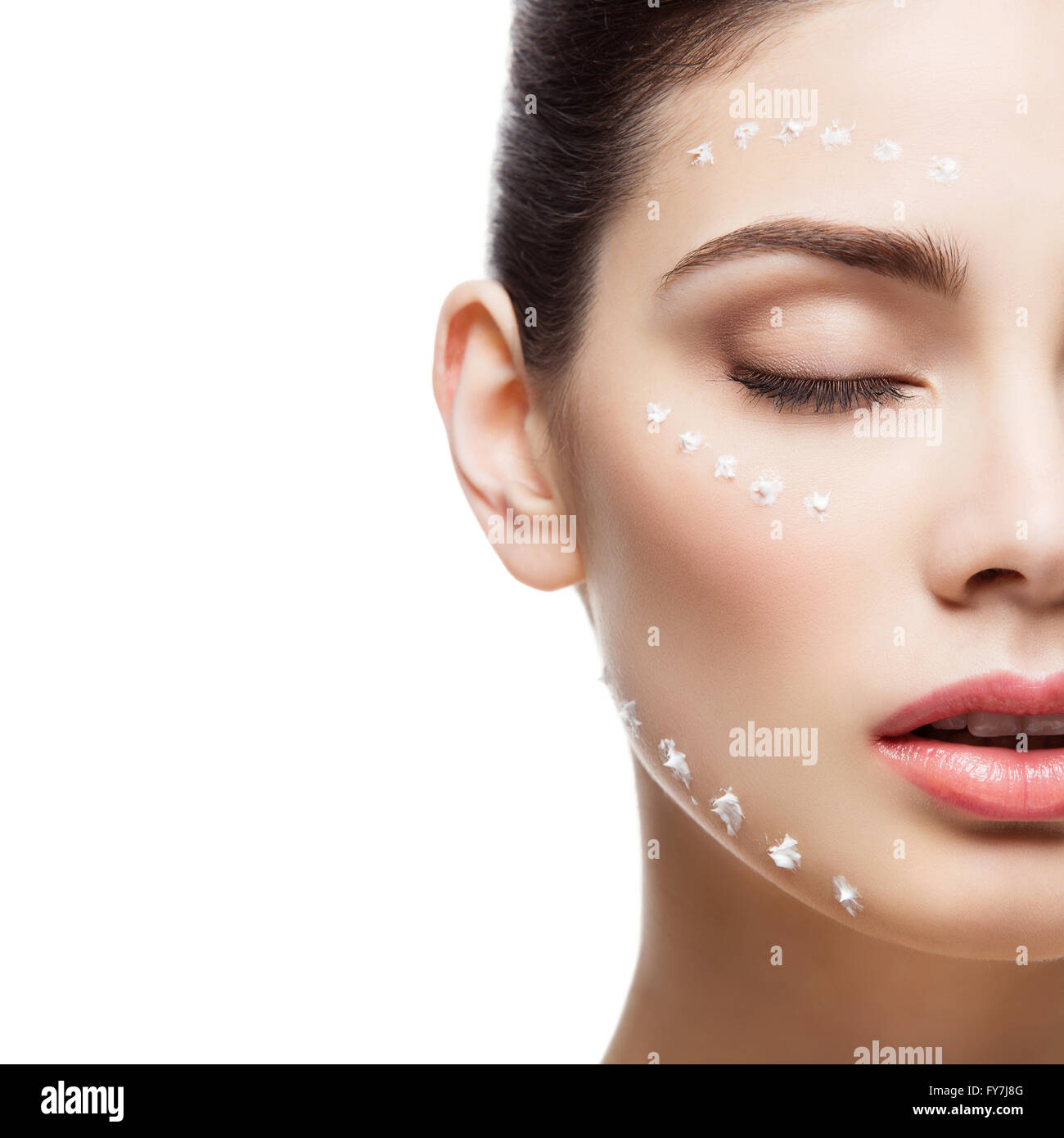 Girl with cream dots on face Stock Photo - Alamy