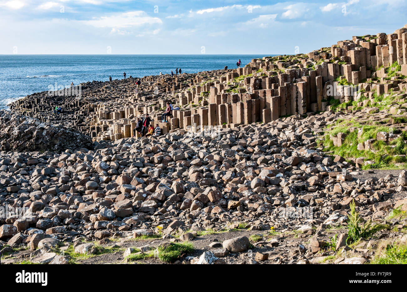 Giants Causeway. Tourists visiting unique geological hexagonal ...