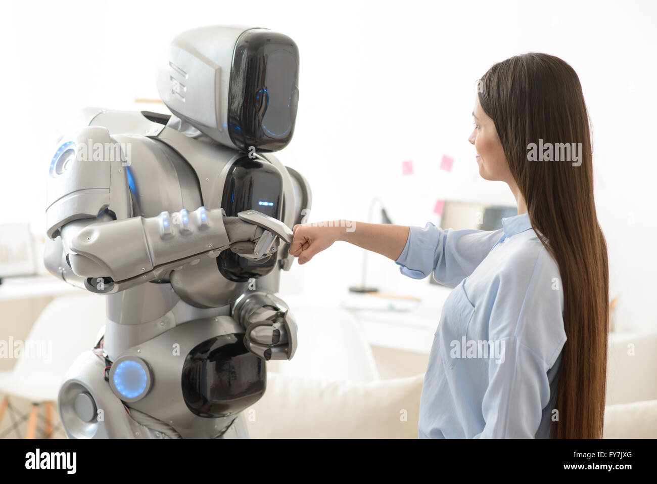 Pleasant girl standing with robot Stock Photo - Alamy
