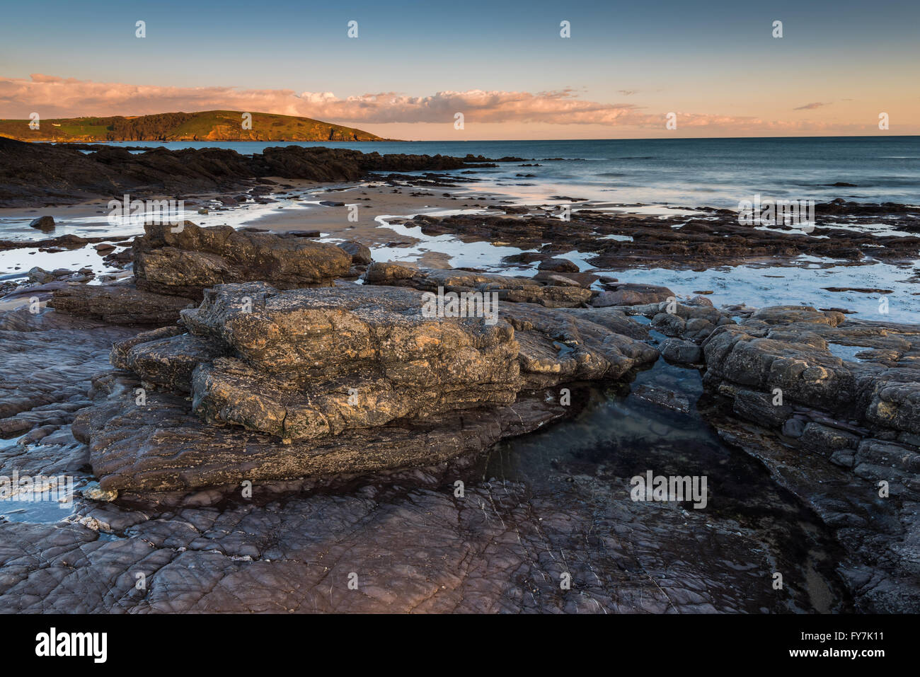 Red rocks on natural beach in Wembury, Devon, UK Stock Photo - Alamy