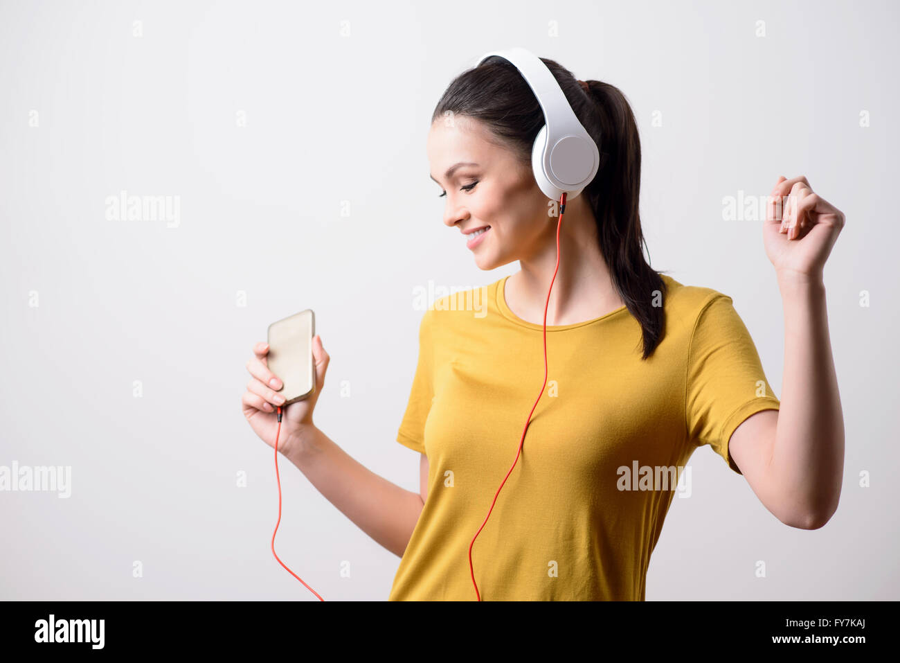 In world of sound. Cheerful delighted positive girl listening to music ...