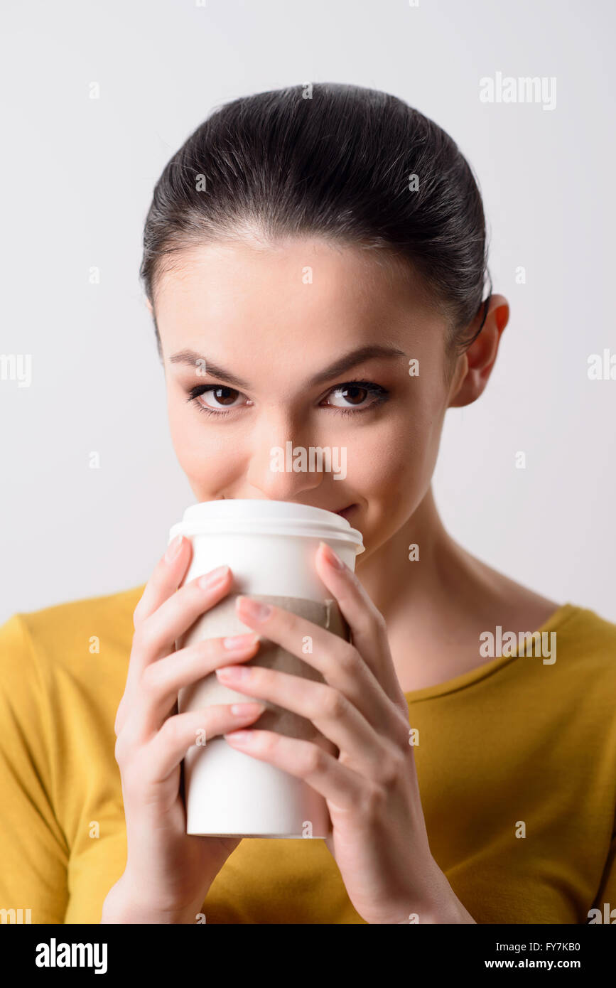 Positive girl drinking coffee Stock Photo - Alamy