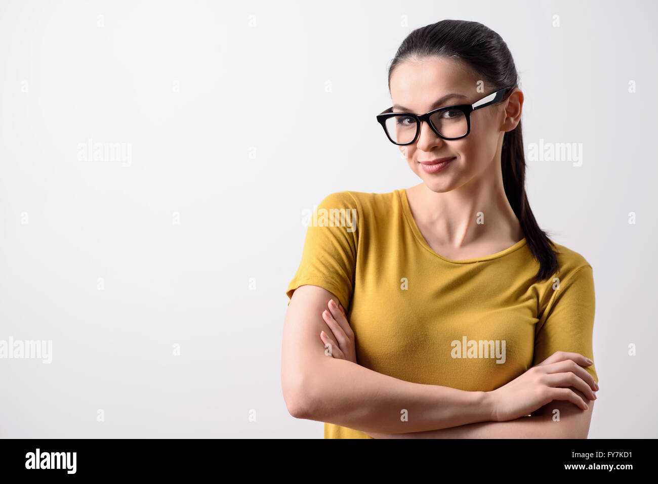 Charming girl folding her hands Stock Photo - Alamy