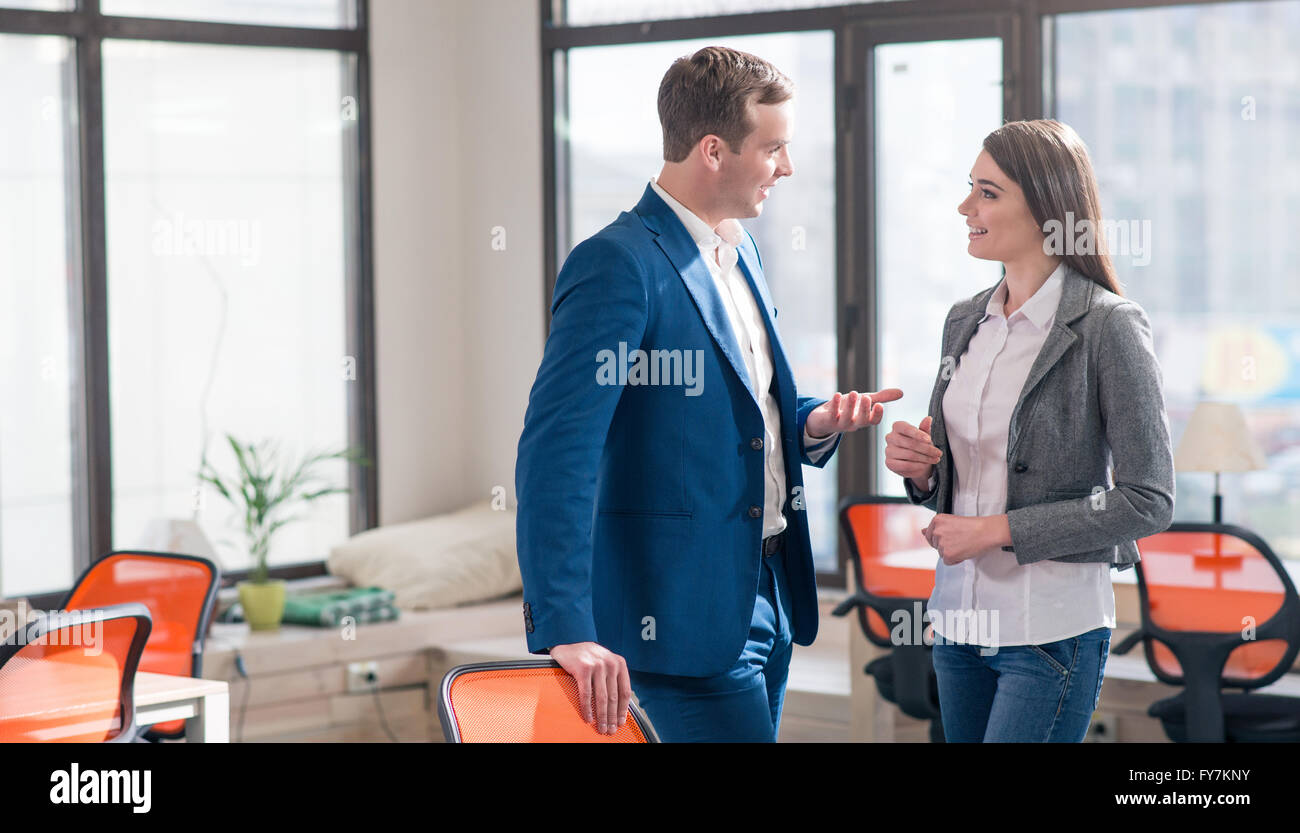 Positive colleagues talking Stock Photo - Alamy