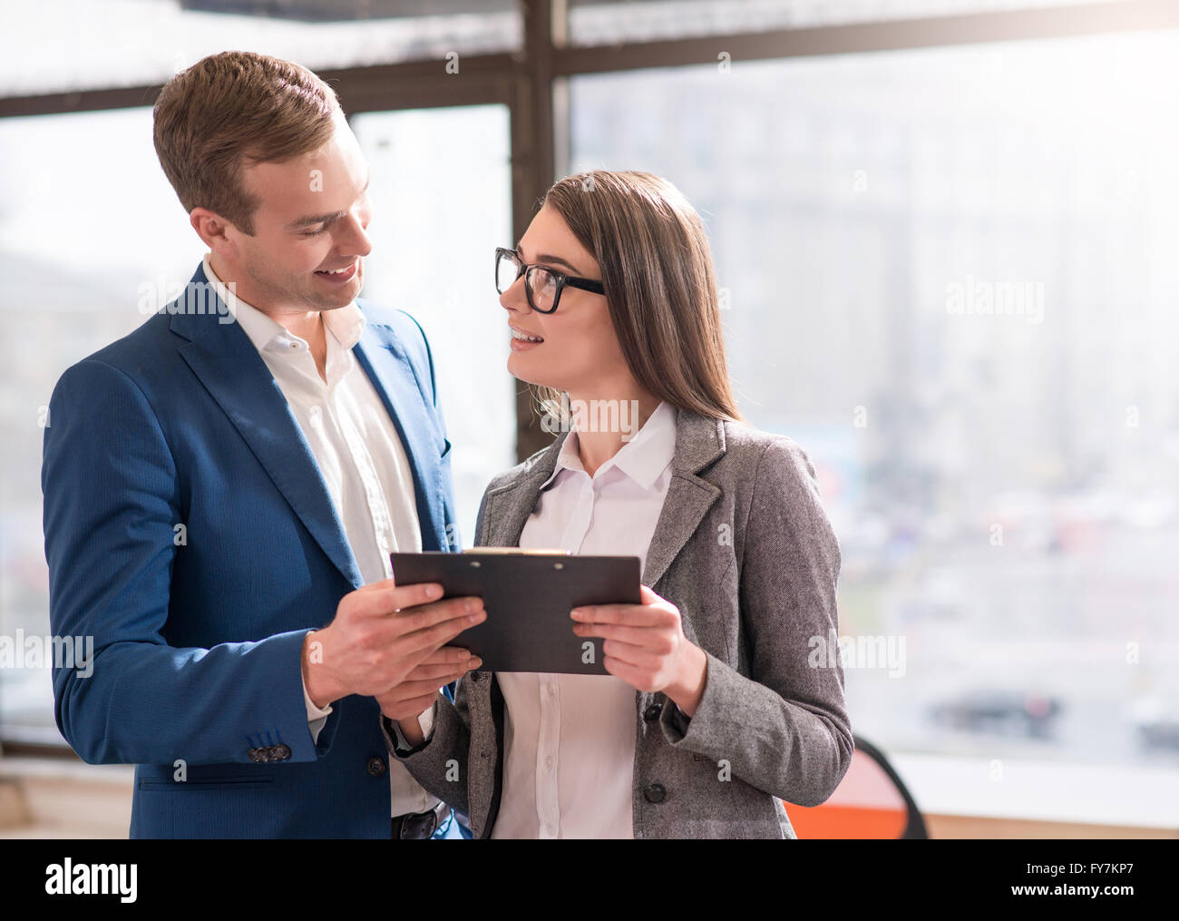 Positive colleagues standing in the office Stock Photo - Alamy