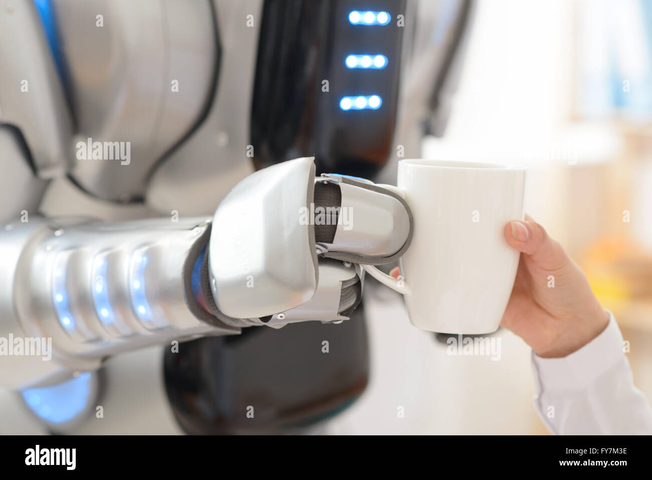 Nice robot giving cup of coffee to a girl Stock Photo - Alamy