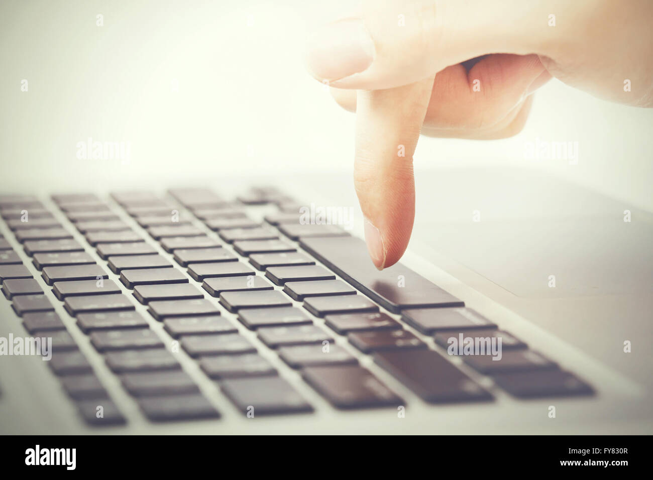 Human hands going to press a button on keypad in white isolated ...