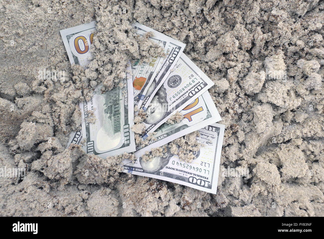 Dollars In Sand Stock Photo - Alamy