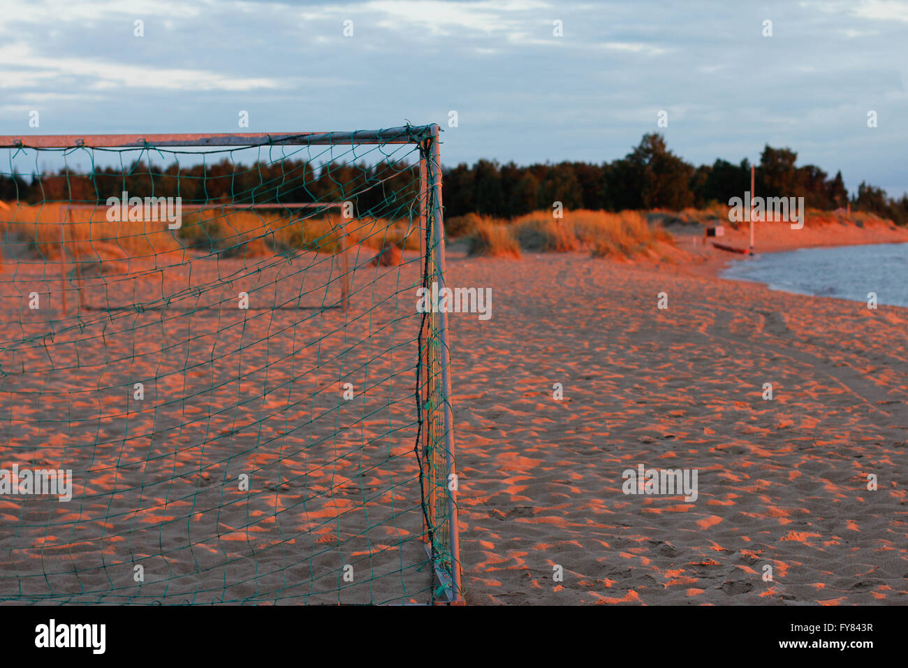 Soccer nets on the beach in sunset Stock Photo - Alamy