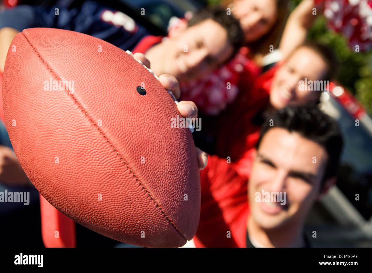 Group of friends doing football tailgating. Cooking food, cheering, etc ...