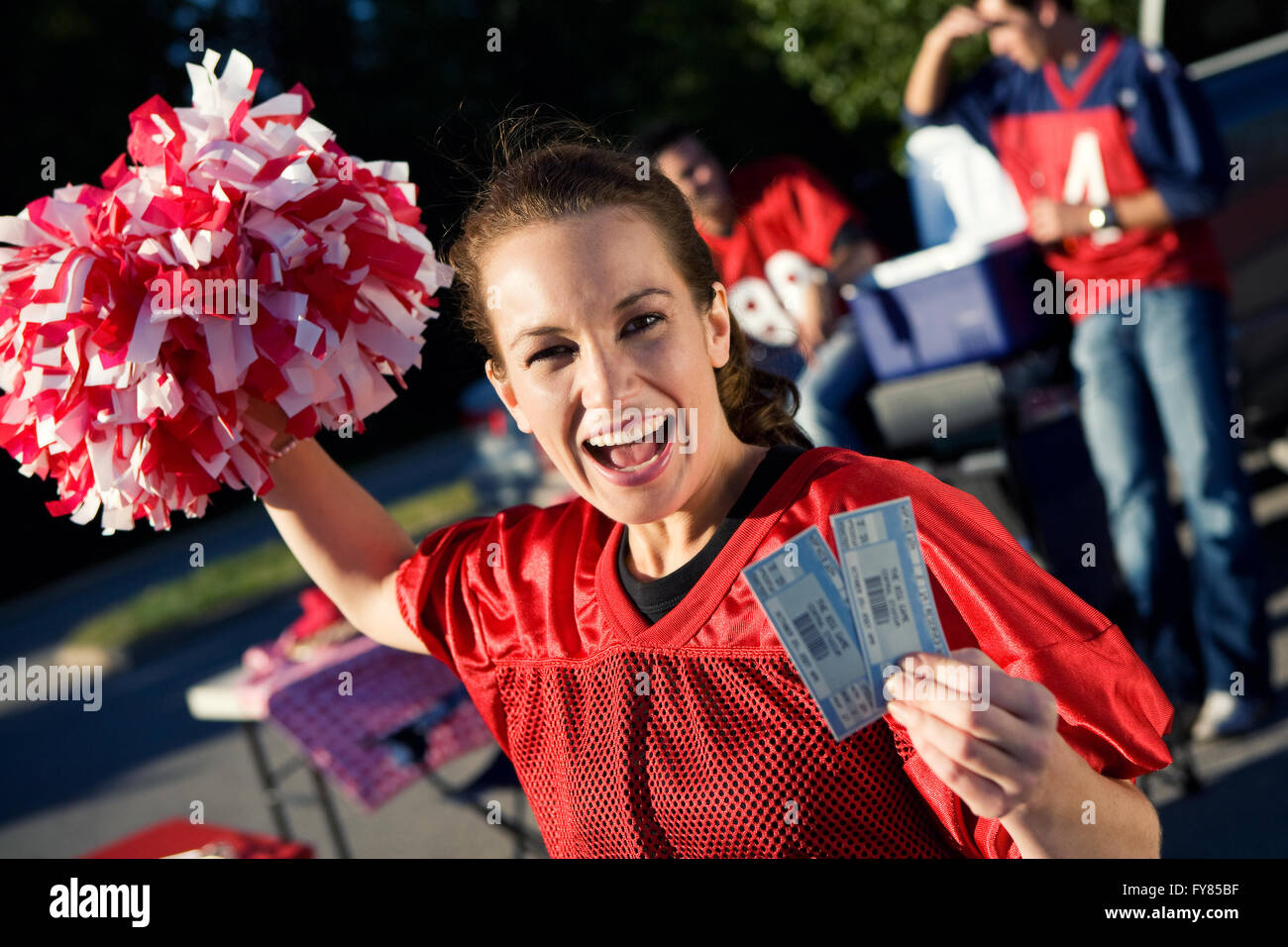 Group of friends doing football tailgating. Cooking food, cheering, etc ...