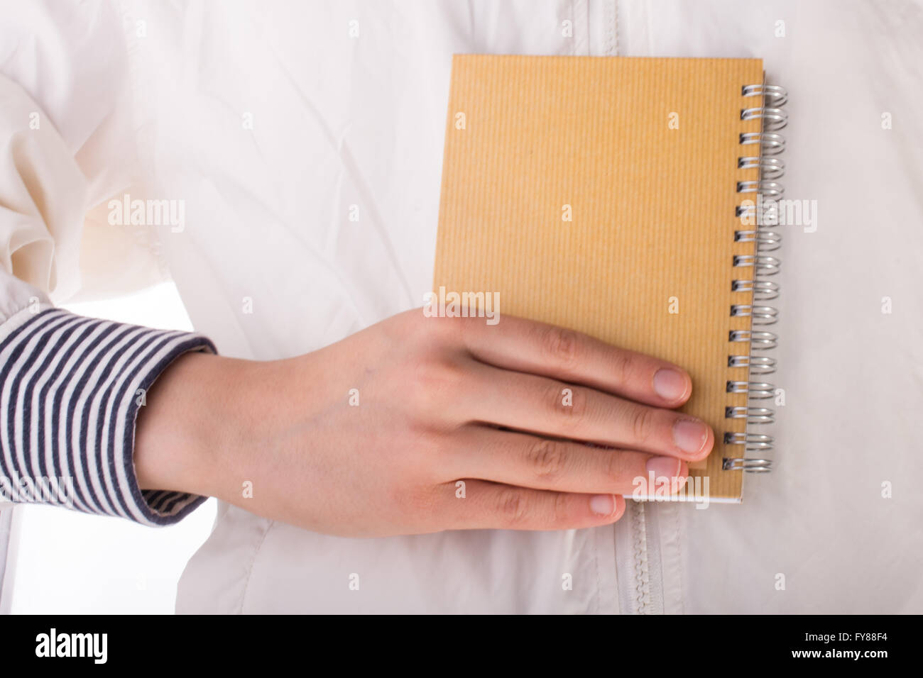Hand holding a notebook on a white background Stock Photo - Alamy