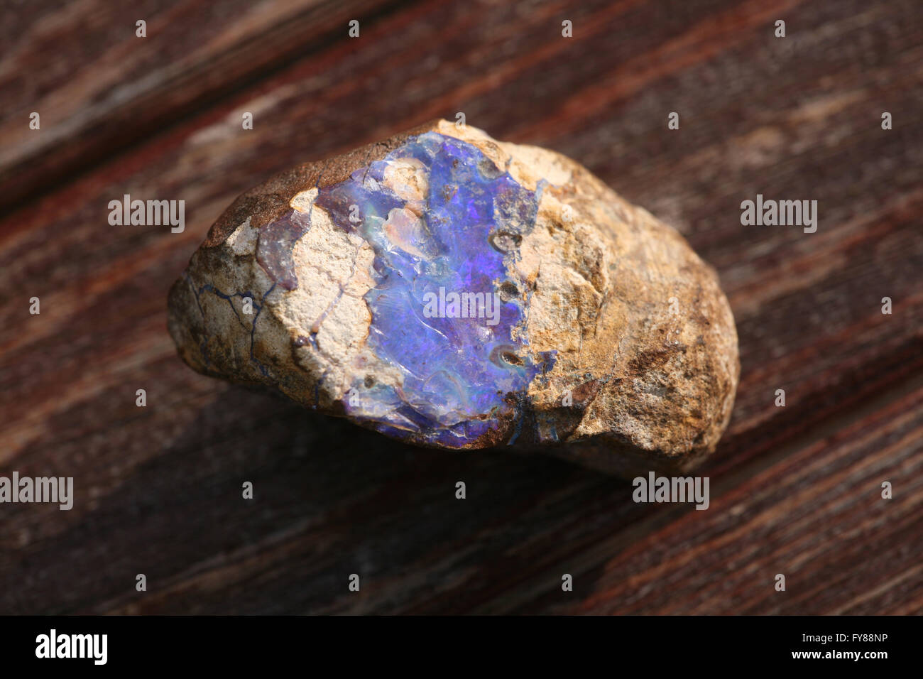 Precious opal on wooden table Stock Photo - Alamy