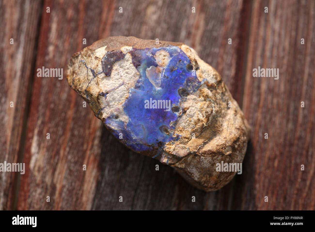 Precious opal on wooden table Stock Photo - Alamy