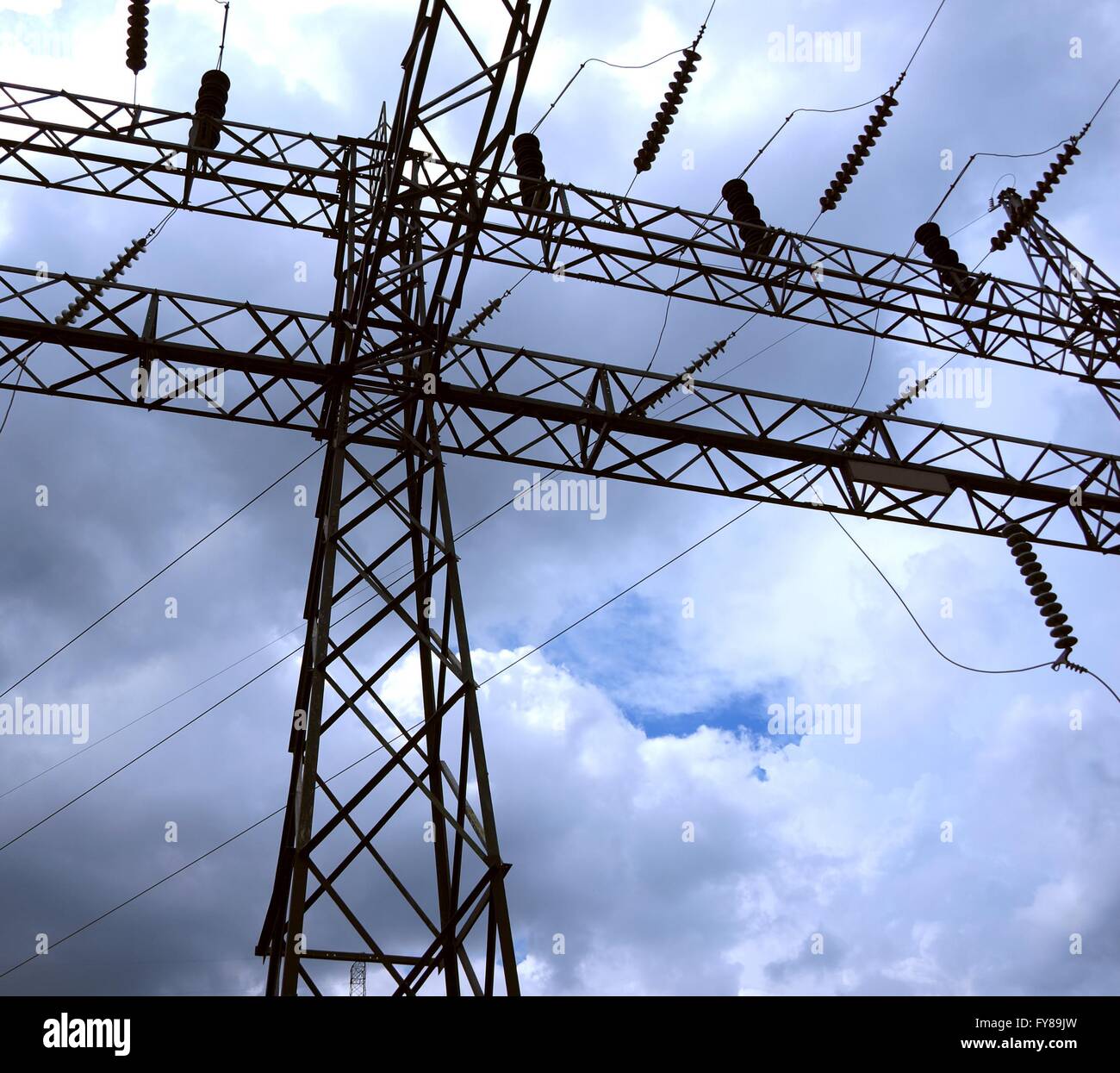 A large electricity pylon with ceramic insulators seen against a ...