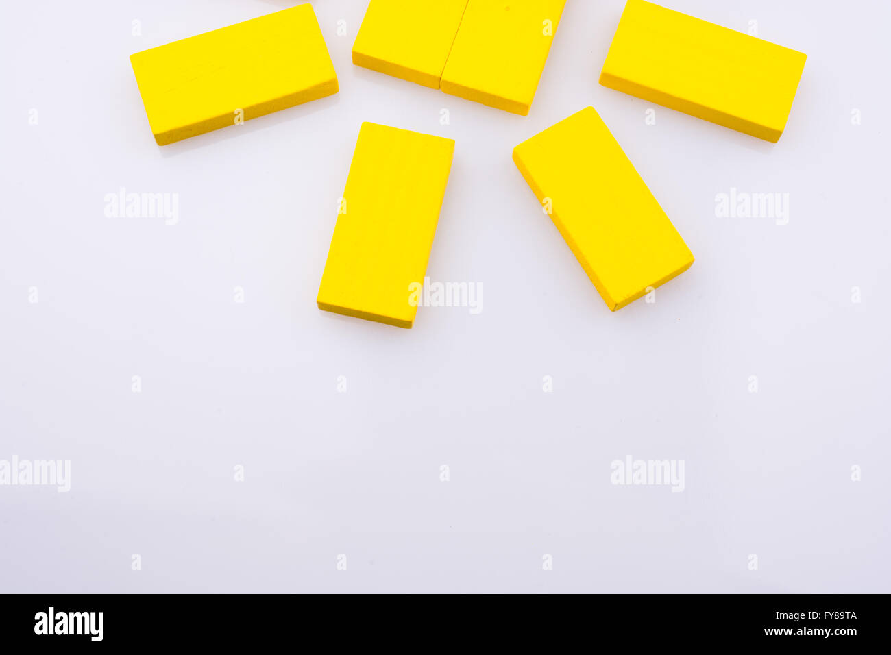 Color Dominoes making a sun on a white background Stock Photo - Alamy