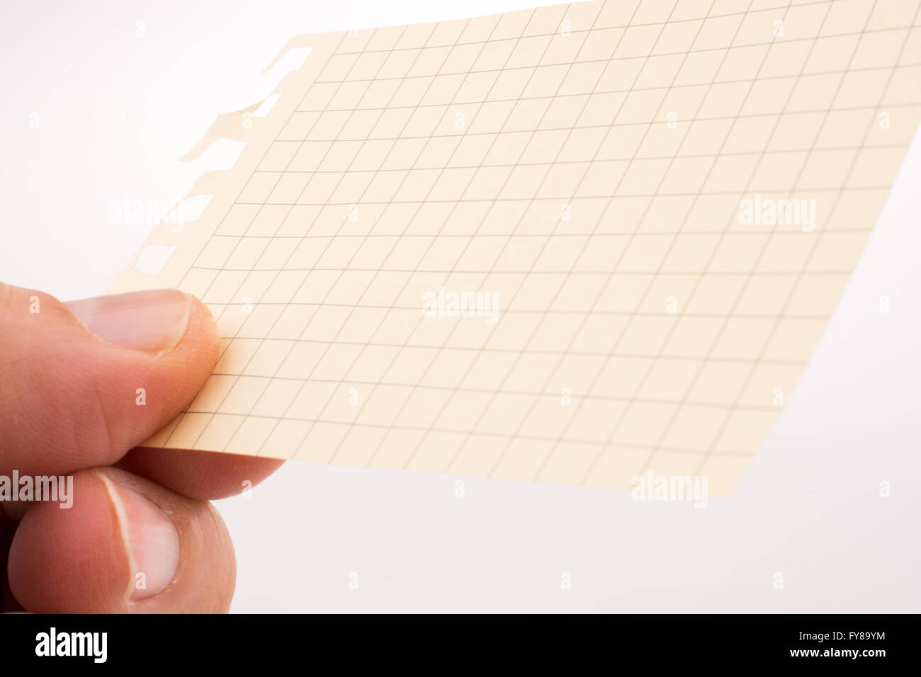 Hand holding a piece of checked paper on a white background Stock Photo ...