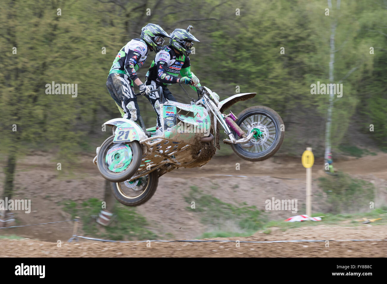 Two racers are high jumping a sidecar in the race. Dynamic motion shot ...