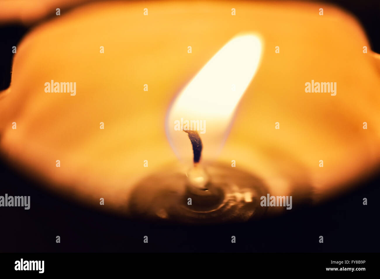 One little candle burning in the dark, macro Stock Photo - Alamy