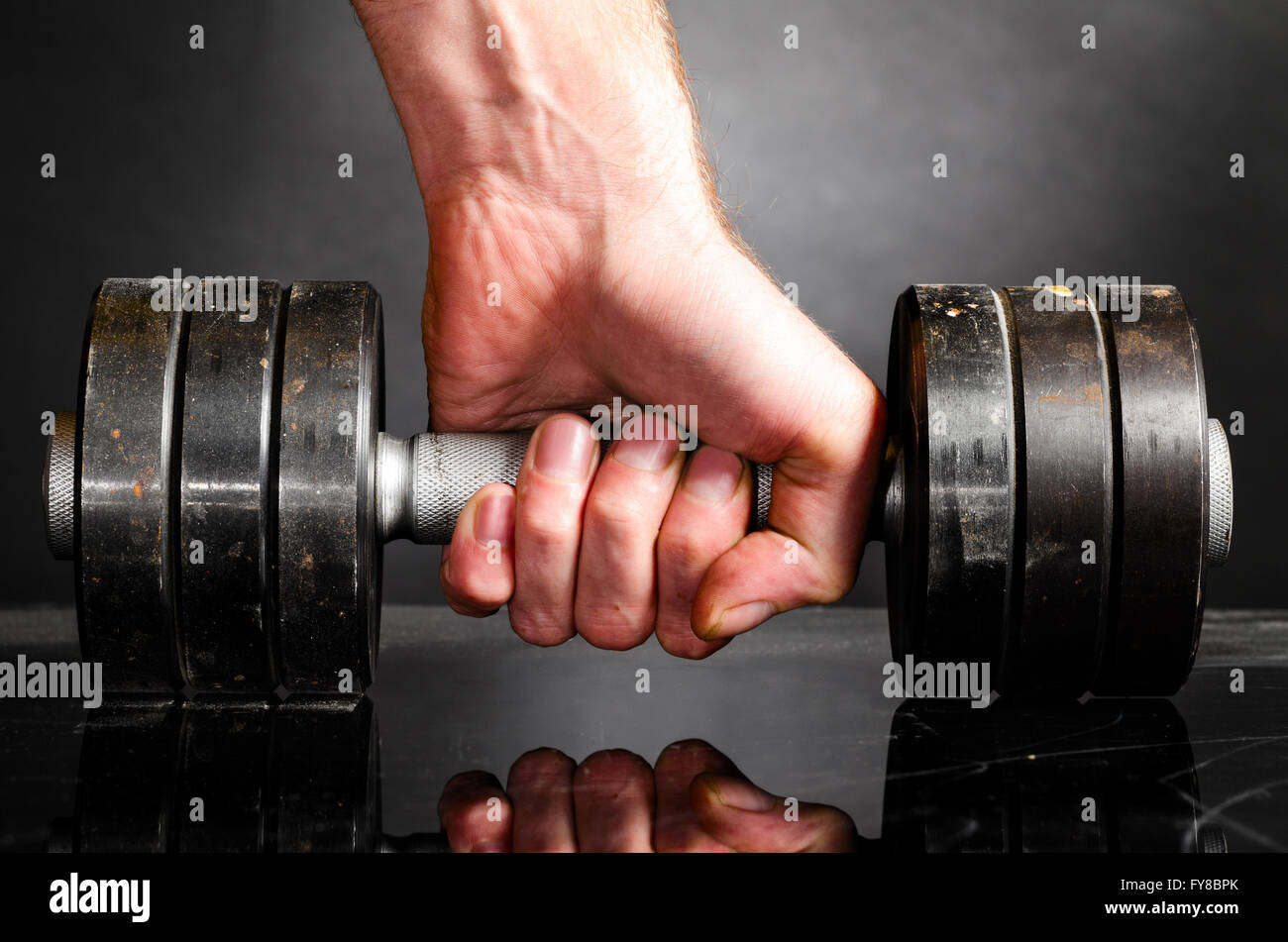male hand is holding metal barbell Stock Photo - Alamy
