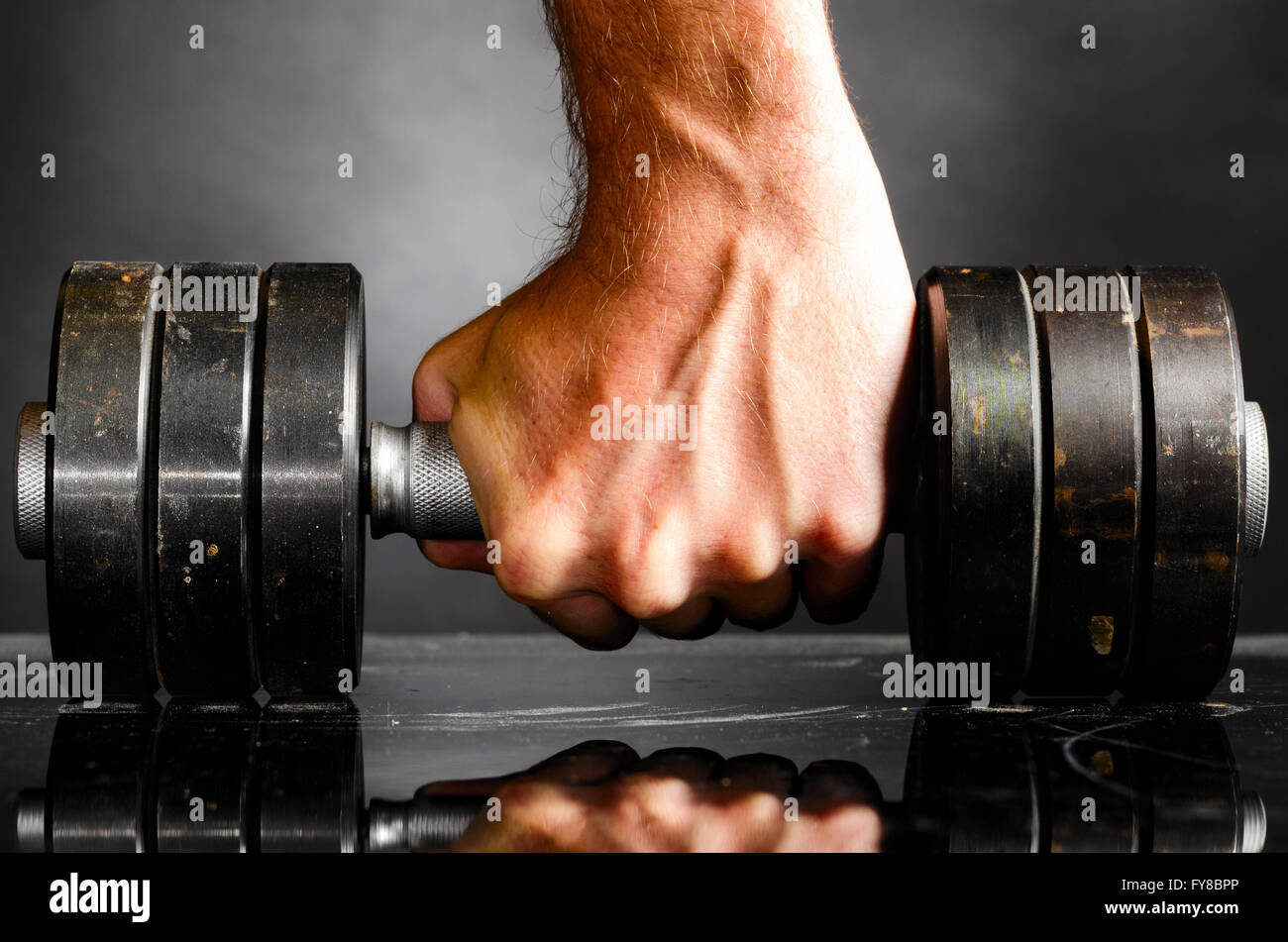male hand is holding metal barbell Stock Photo - Alamy