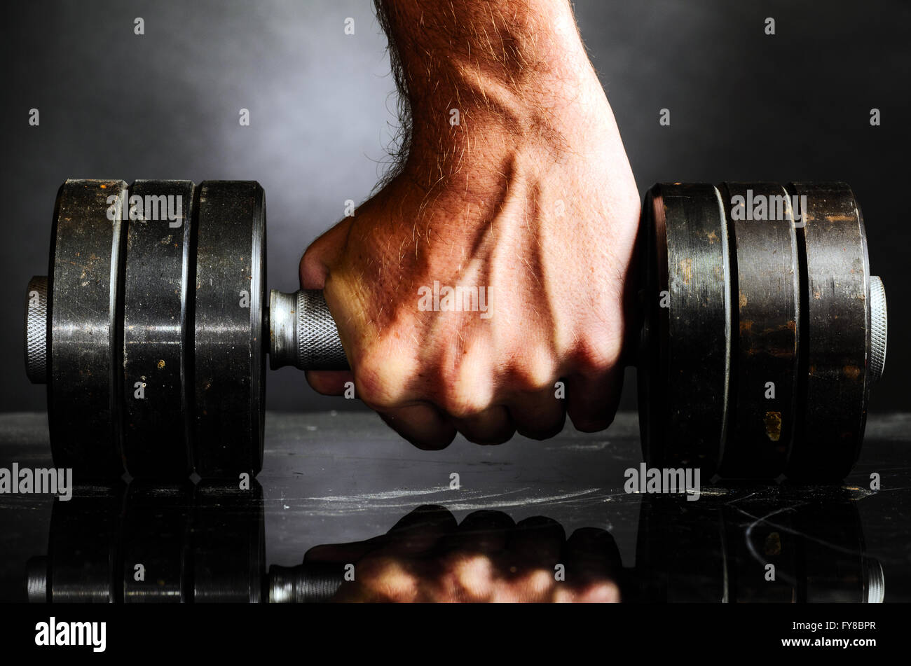 male hand is holding metal barbell Stock Photo - Alamy