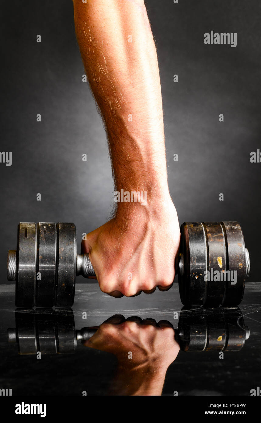 male hand is holding metal barbell Stock Photo - Alamy
