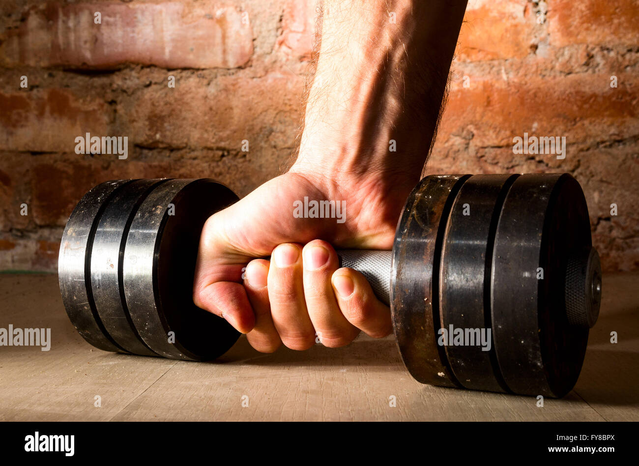 male hand is holding metal barbell Stock Photo - Alamy