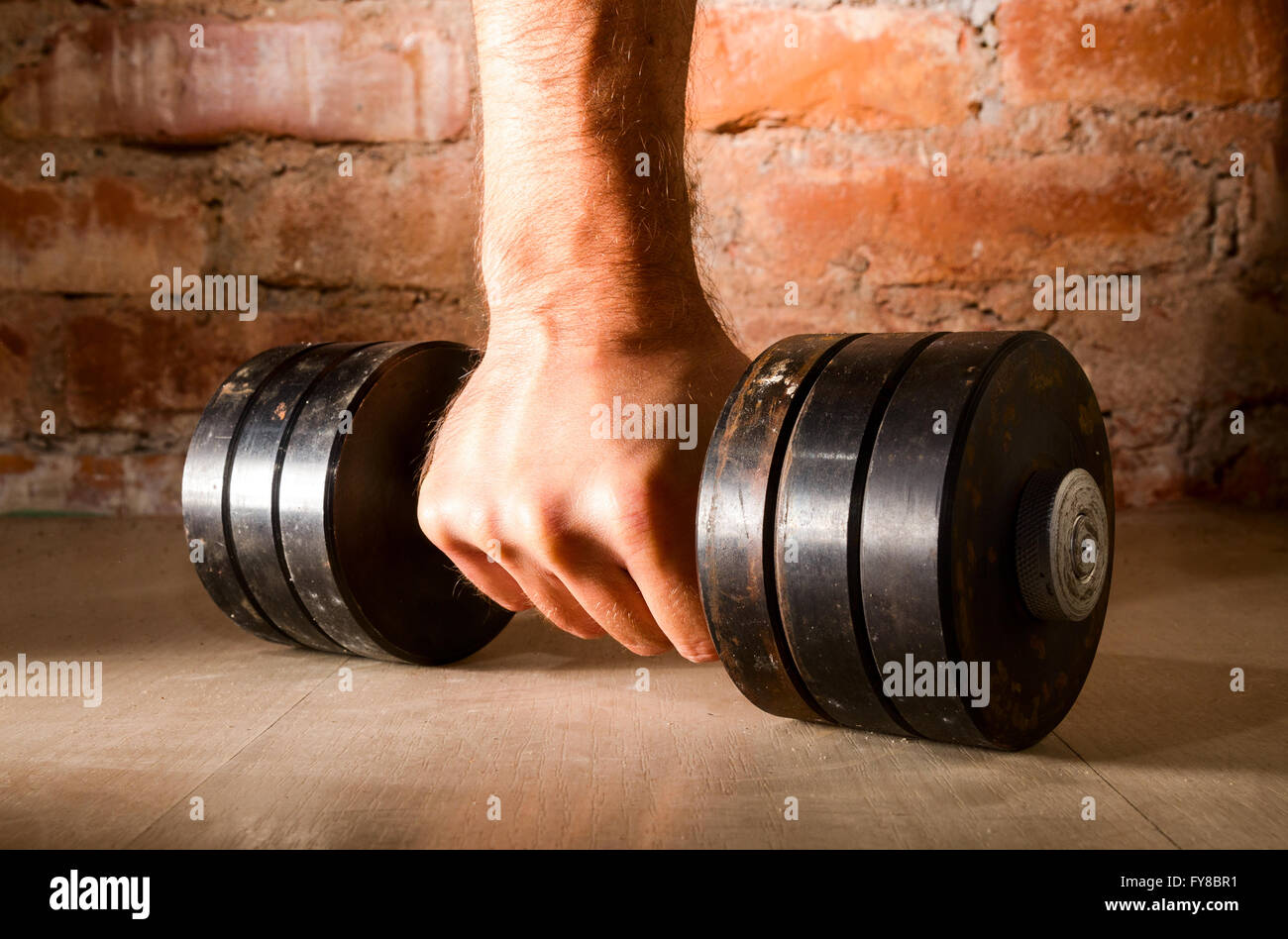 male hand is holding metal barbell Stock Photo - Alamy