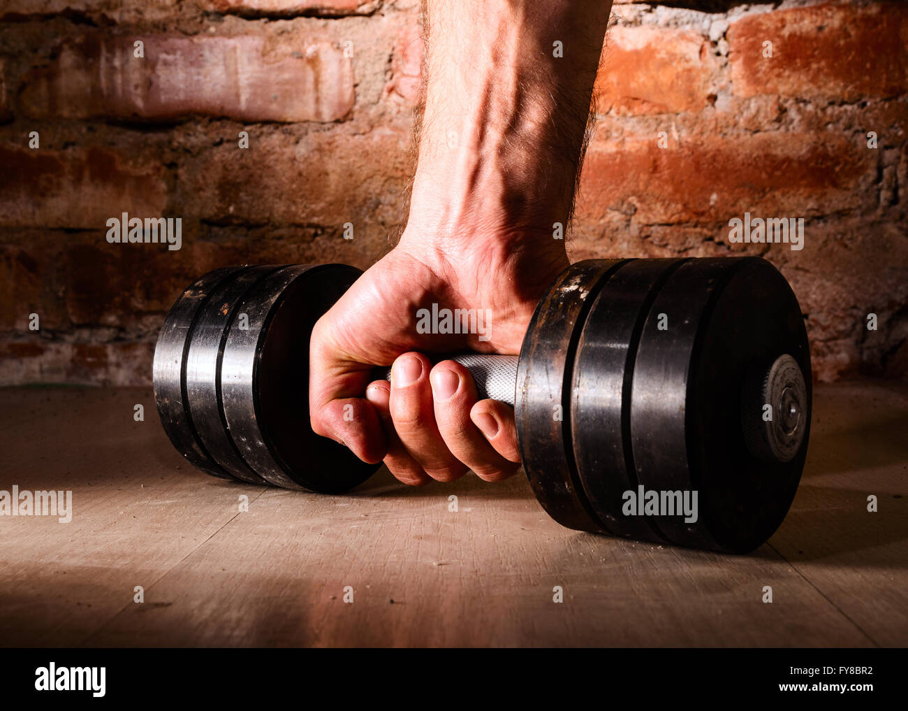 male hand is holding metal barbell Stock Photo - Alamy