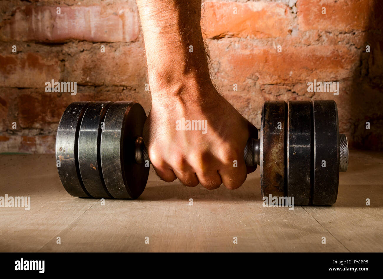 male hand is holding metal barbell Stock Photo - Alamy