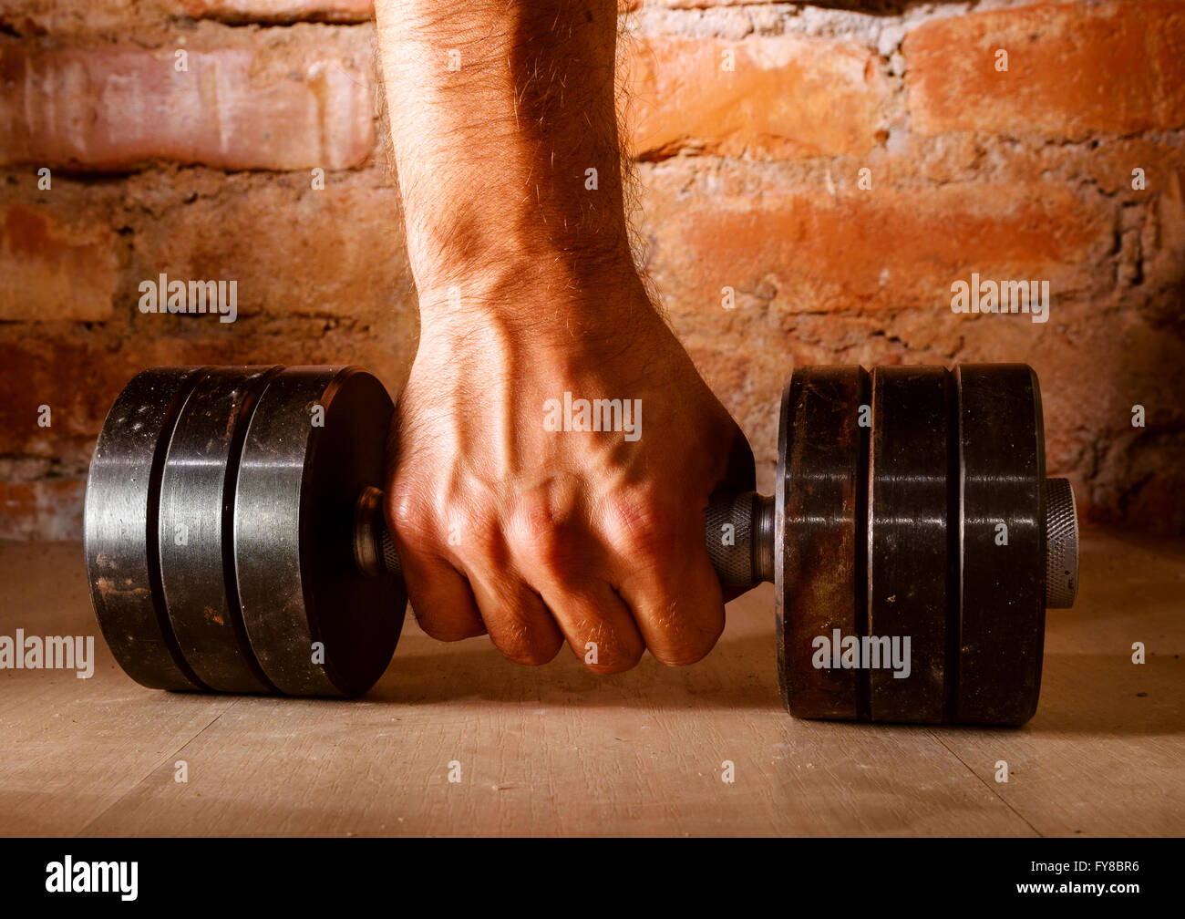 male hand is holding metal barbell Stock Photo - Alamy
