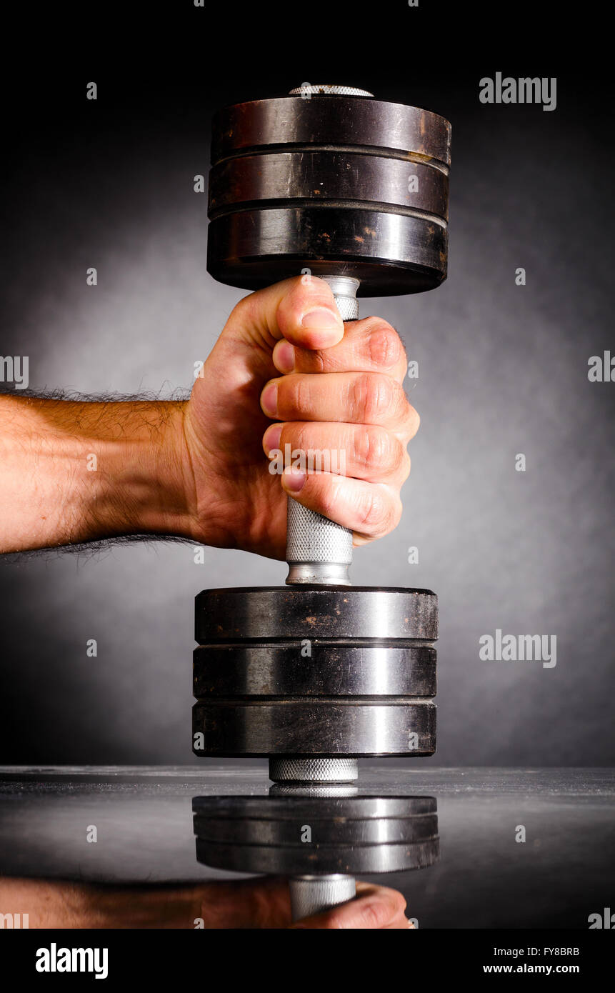 male hand is holding metal barbell Stock Photo - Alamy