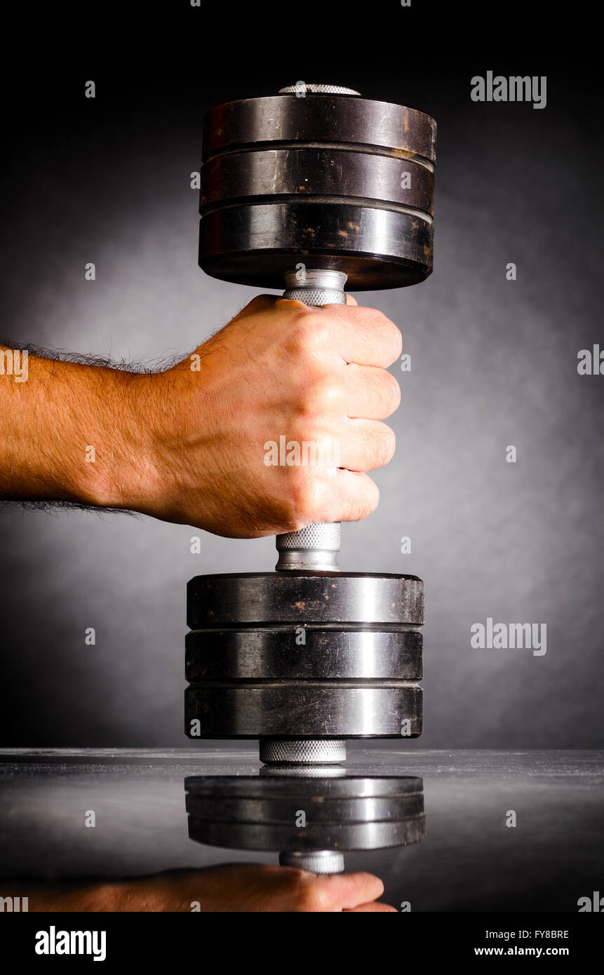 male hand is holding metal barbell Stock Photo - Alamy