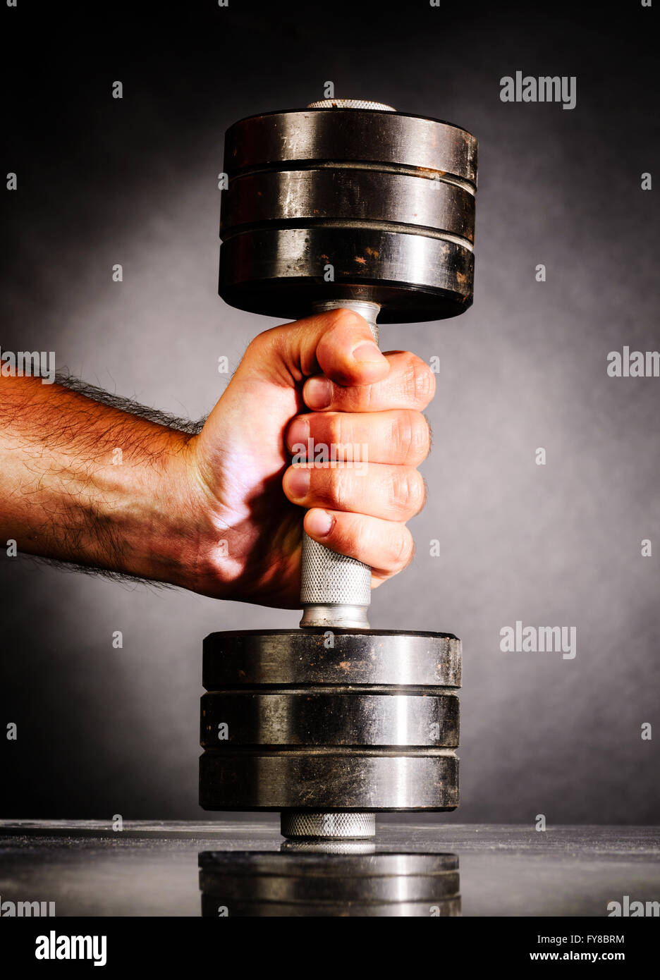 male hand is holding metal barbell Stock Photo - Alamy