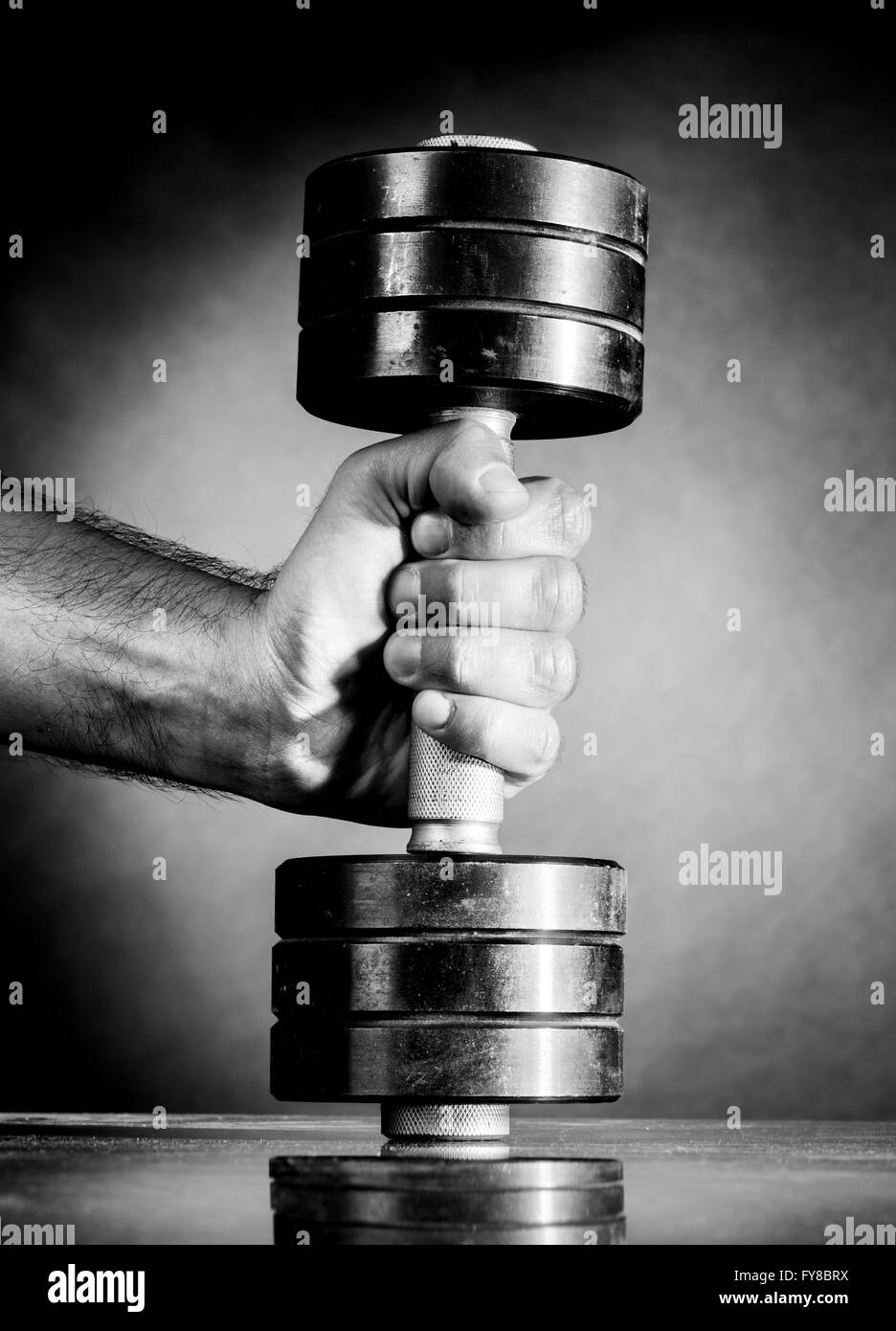 male hand is holding metal barbell Stock Photo - Alamy