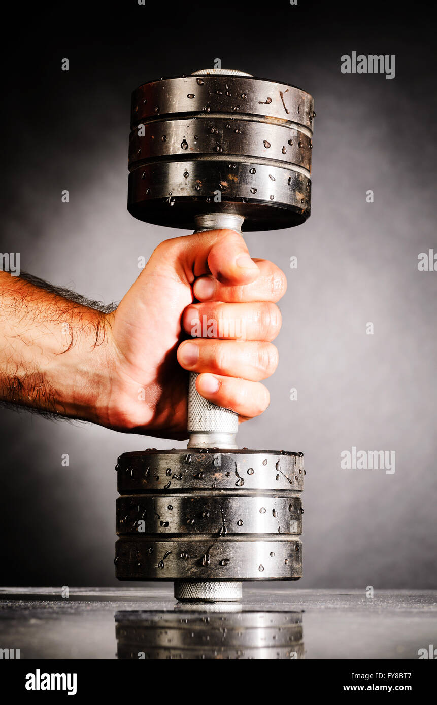 male hand is holding metal barbell Stock Photo - Alamy
