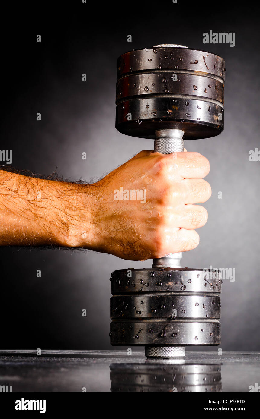 male hand is holding metal barbell Stock Photo - Alamy