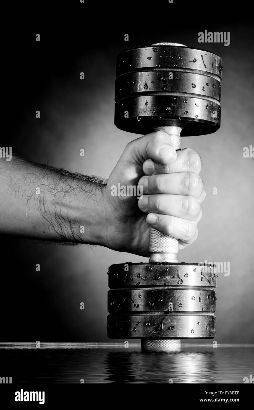 Man hand holding dumbbell Black and White Stock Photos & Images - Alamy
