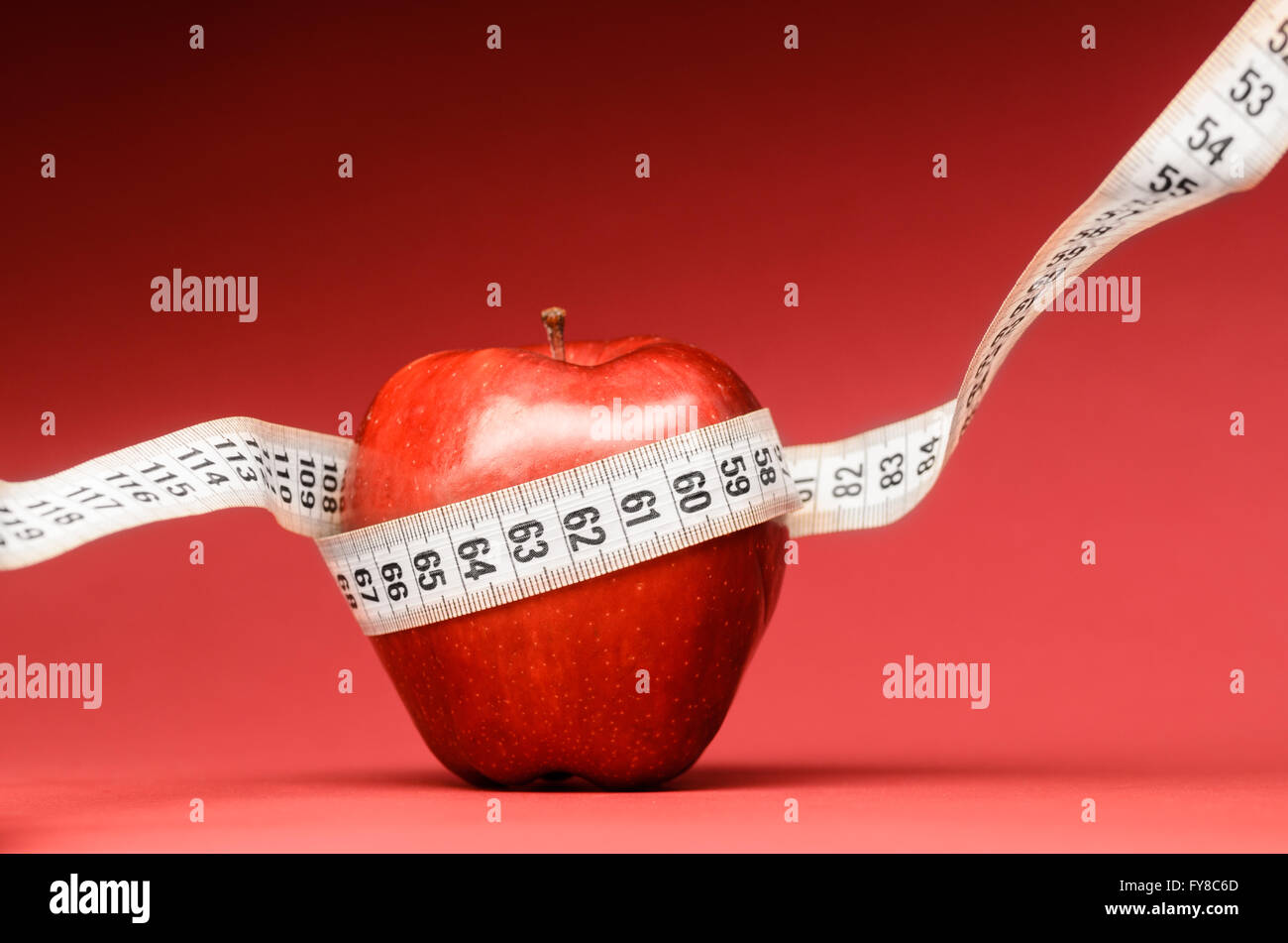 Delicious apple with measuring tape Stock Photo - Alamy