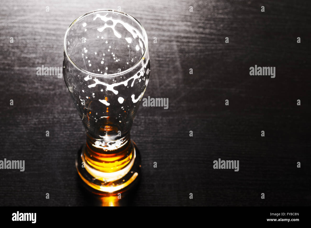 drained glass of lager beer on table Stock Photo - Alamy